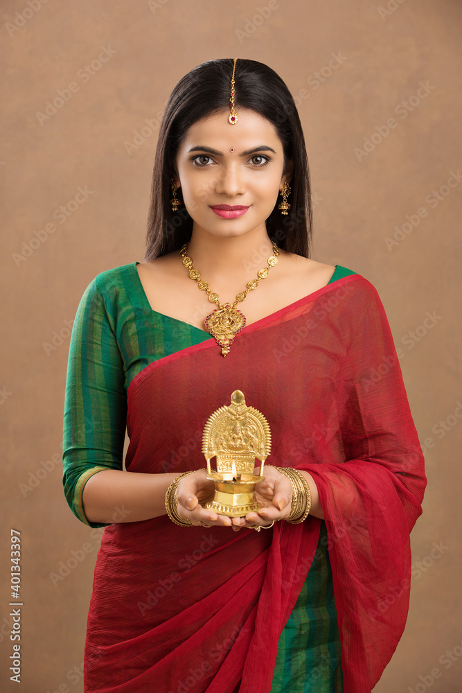 Hindu Indian young women holding Deepam in hands studio shot ...