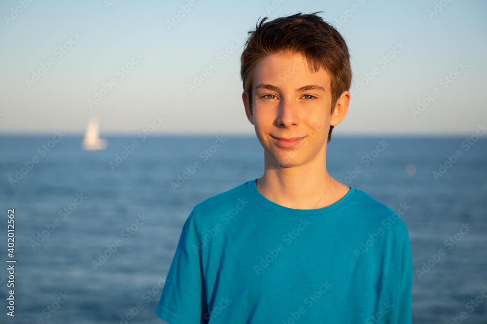 Handsome young happy boy at beach. Beautiful calm smiling teen boy ... Handsome young happy boy at beach. Beautiful calm smiling teen boy ...