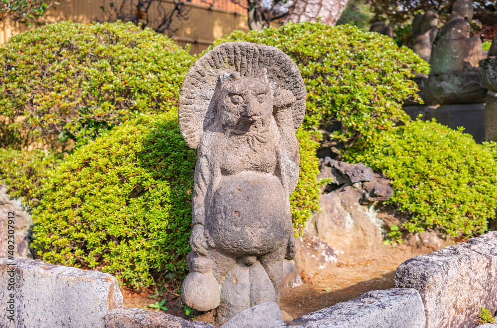 Stone sculpture depicting a japanese mythical Tanuki racoon-dog ...