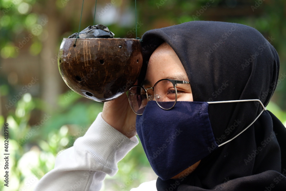 Beautiful female tourists who wear hijab visiting flower gardens during ...