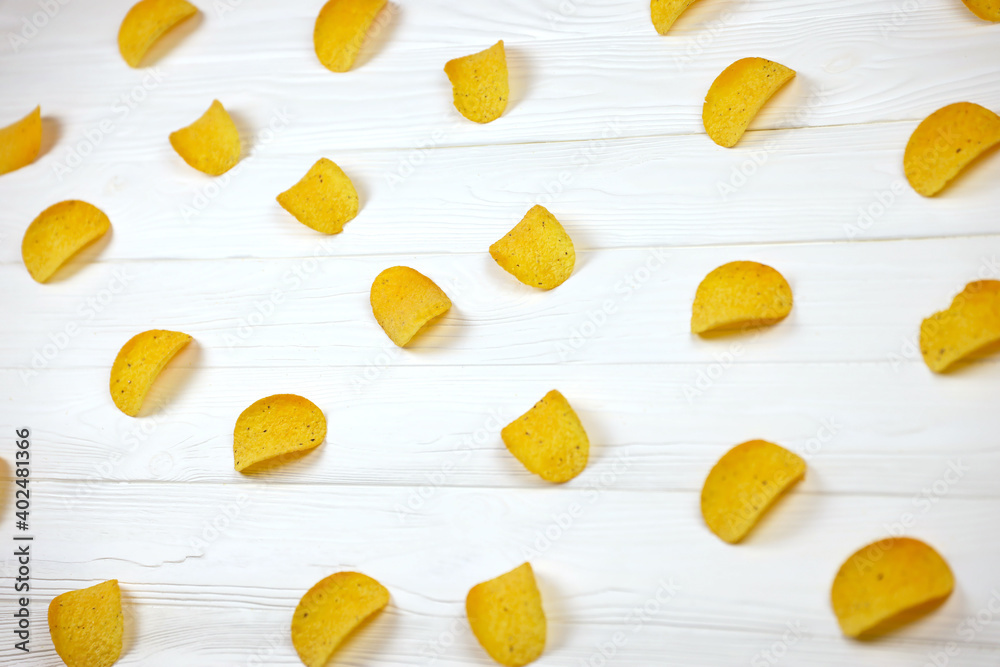 Many orange Pringles potato snack chips on white wooden table. Pringles ...