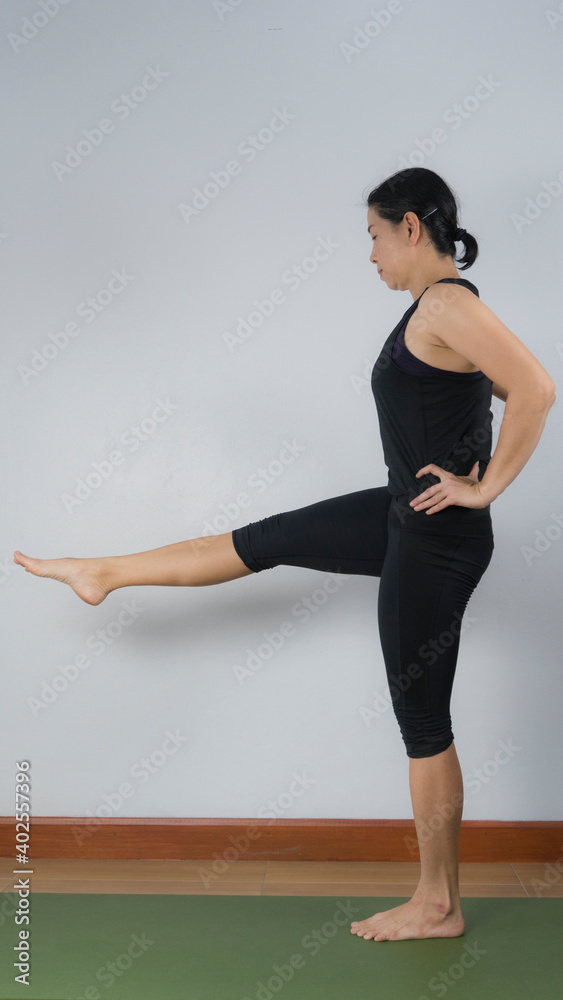 Asian young woman wear a black yoga outfit . Practicing yoga Standing ...