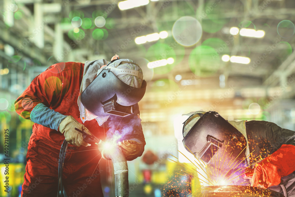 welder man Two welding worker at piping shop factory by Mig and Tig ...