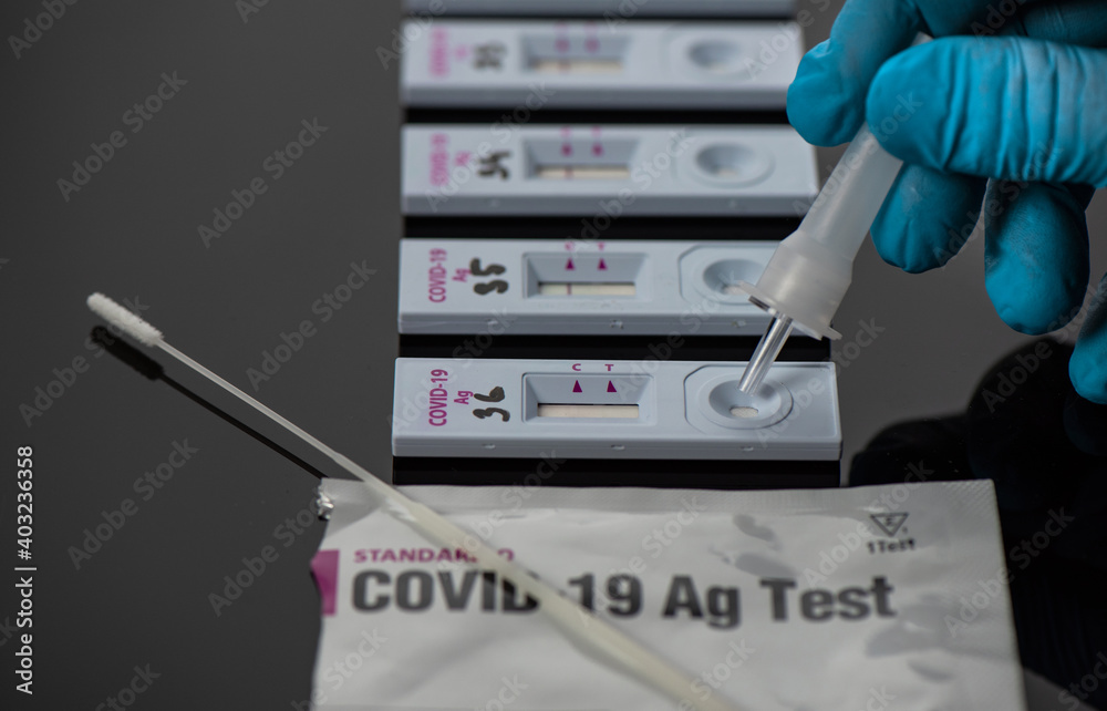 Covid-19 Ag rapid antigen kits seen on a table during dripping swab ...