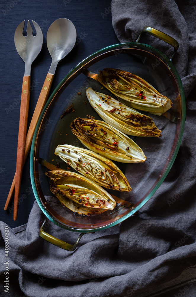 Overhead vieuw of oven baked chicory of endives on a fire fixed dish ...
