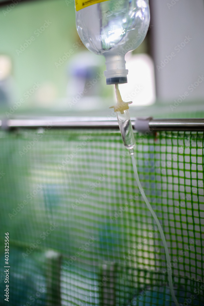Saline solution drip to patients on the hospital bed during wait for ...