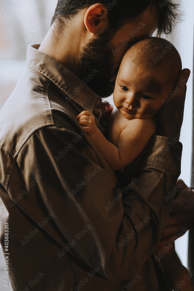 Caucasian father kissing newborn baby. Parent holding rocking child ...