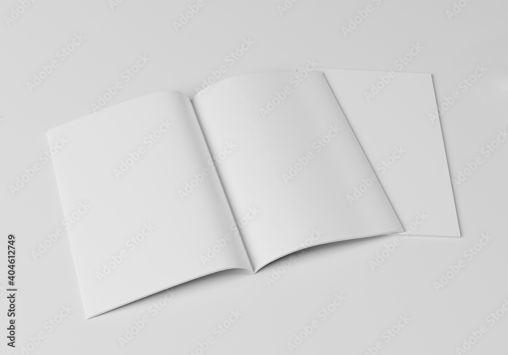 Blank magazine open in half with another magazine underneath showing ...