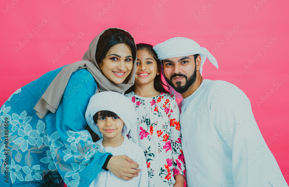Happy family in Dubai. parents and children with traditional emirati ...