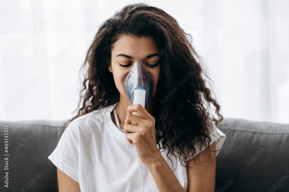 Close-up photo of sick african american woman with an inhaler ...