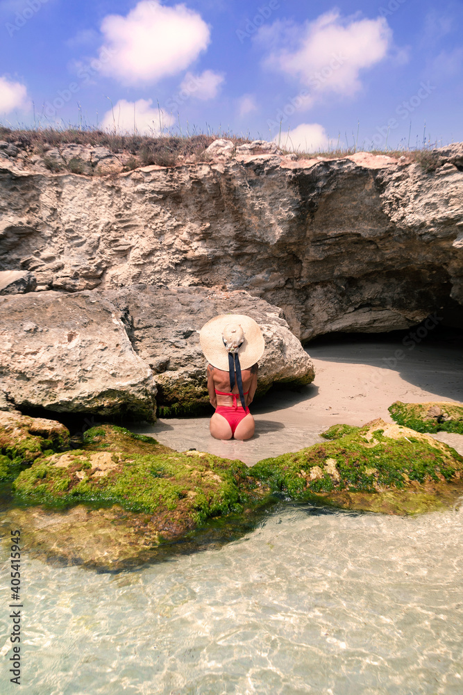Modella in bikini tra le rocce Stock Photo | Adobe Stock