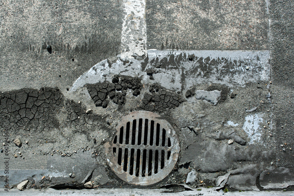 Down the drain water grate view on textured pavement backdrop Stock ...