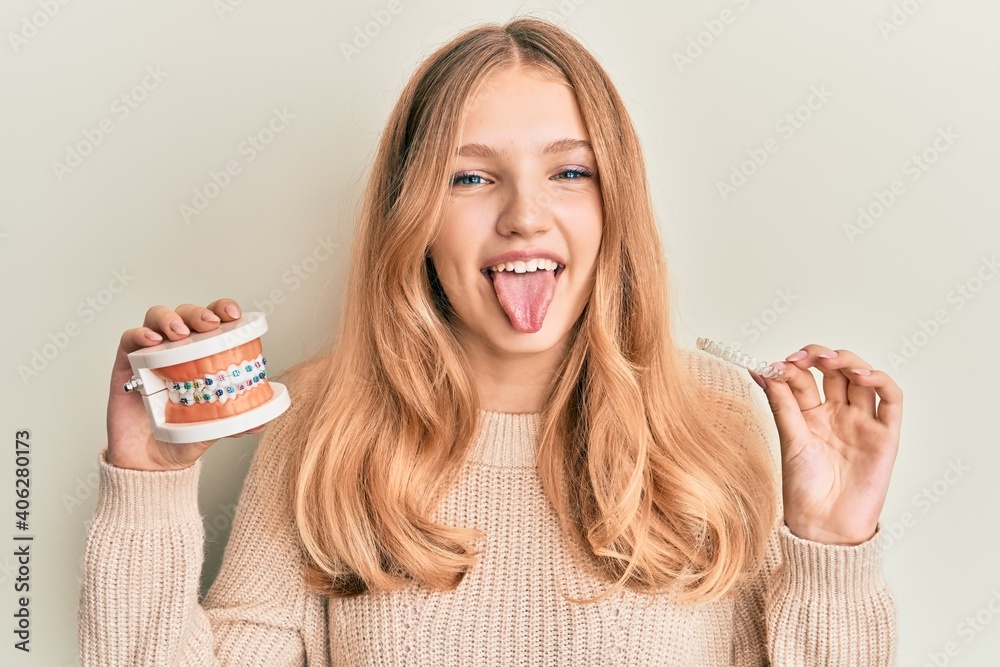 Beautiful young caucasian girl holding invisible aligner orthodontic ...