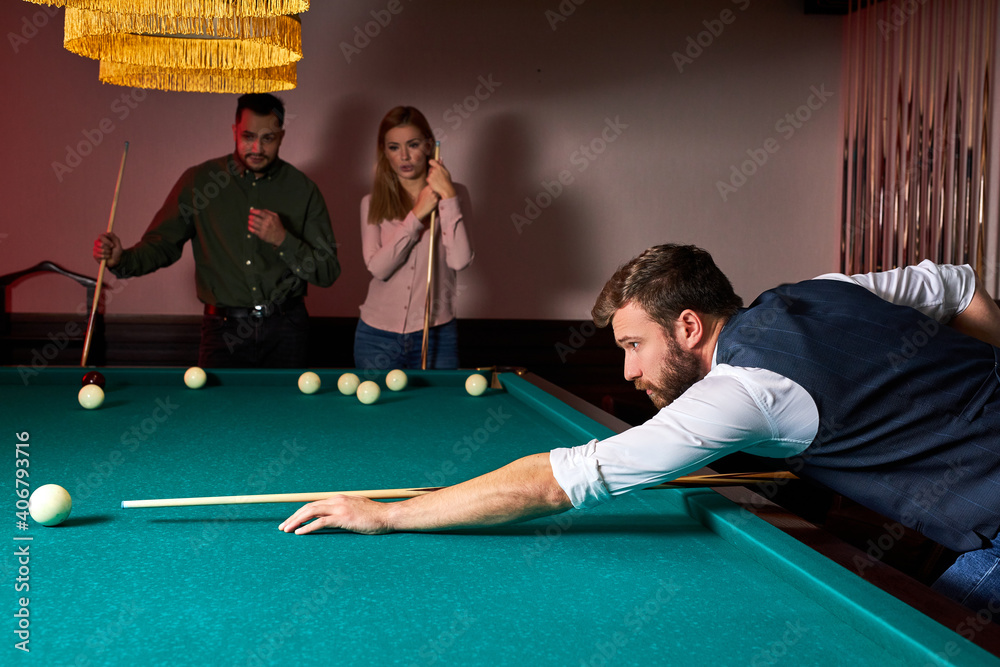 man is playing snooker, he is aiming to shoot the snooker ball ...