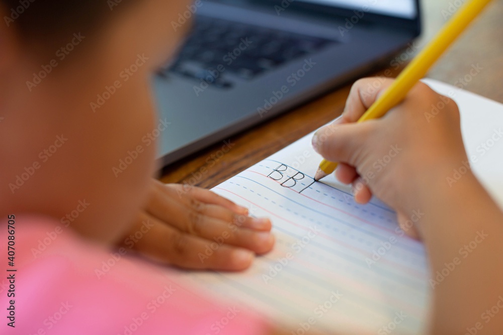 Children learning how to write the alphabet, pencil and notebook ...