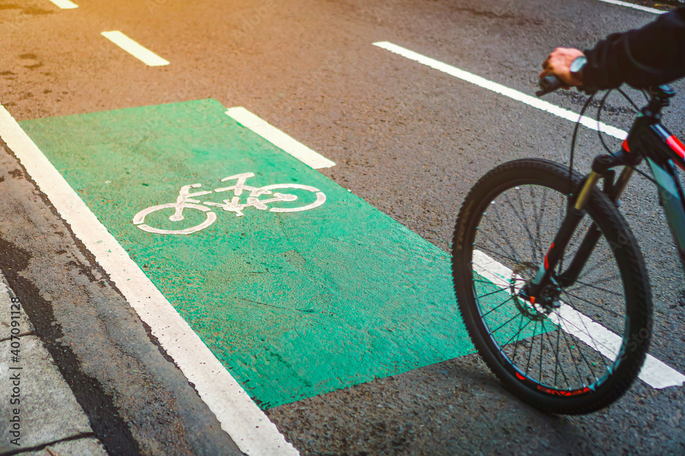 Bikers crossing a bike path for cyclist beside the main traffic road in ...