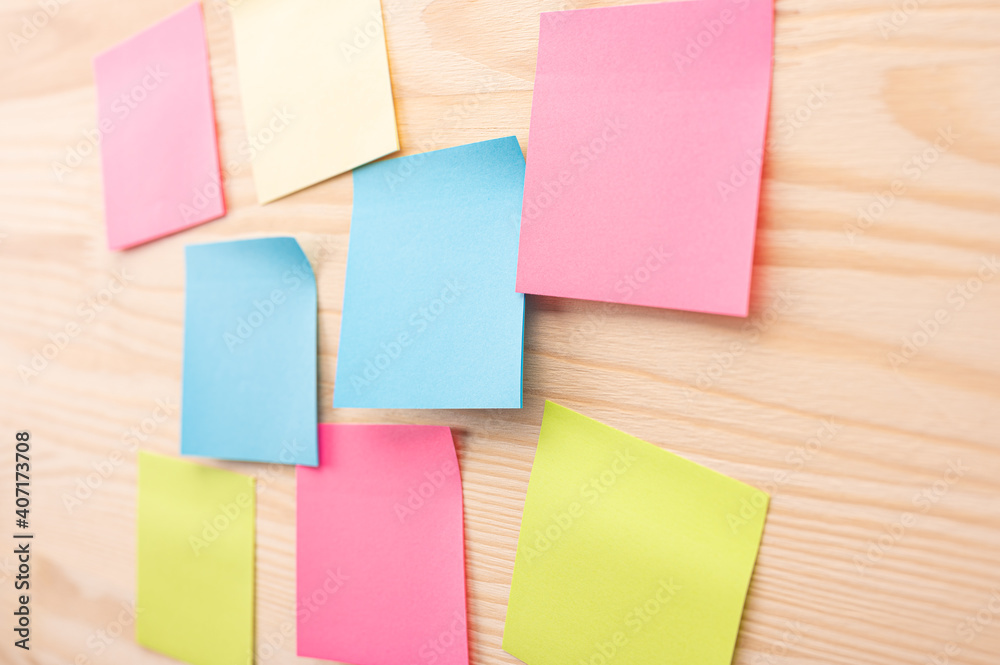 Colorful sticky notes with things to do on office board. Using task ...