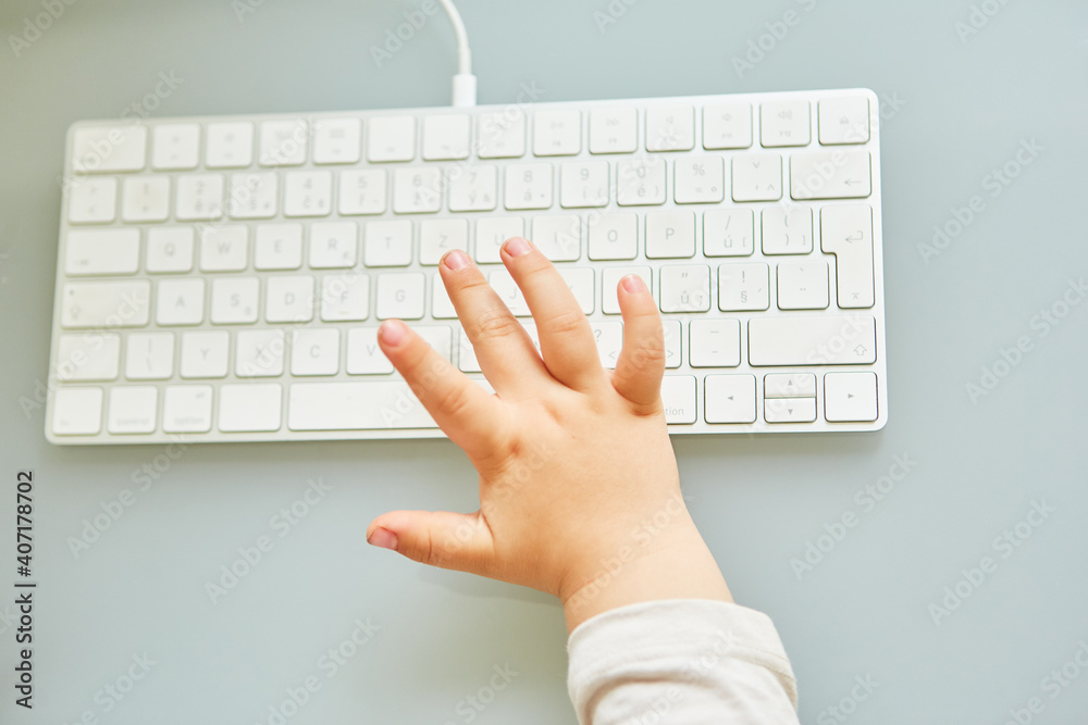 Hand of baby is typing on computer keyboard Stock Photo | Adobe Stock