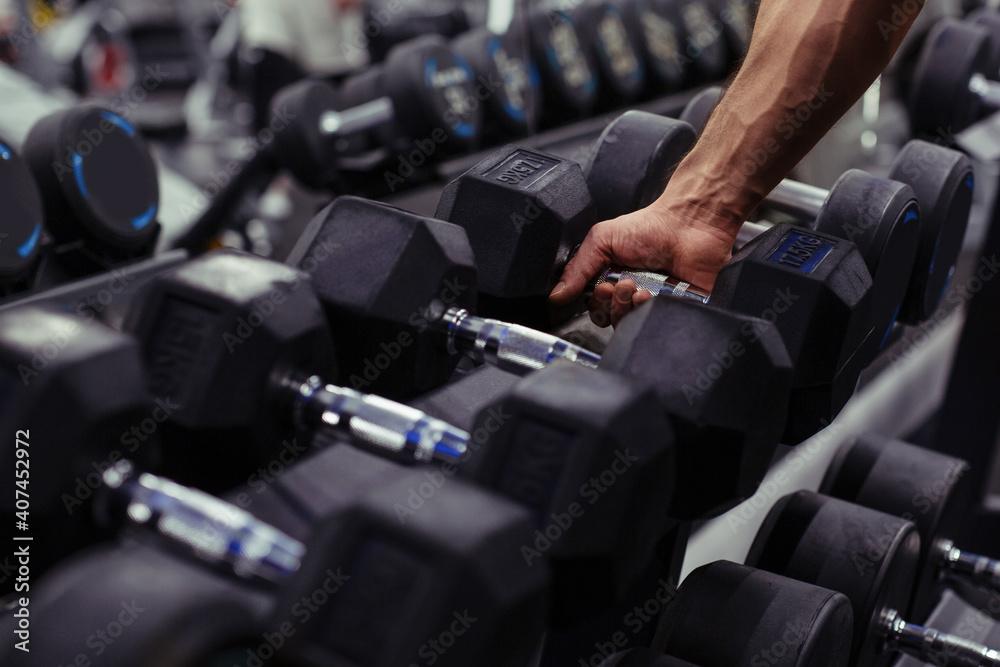 Rows of dumbbells in the gym with hand Stock Photo | Adobe Stock