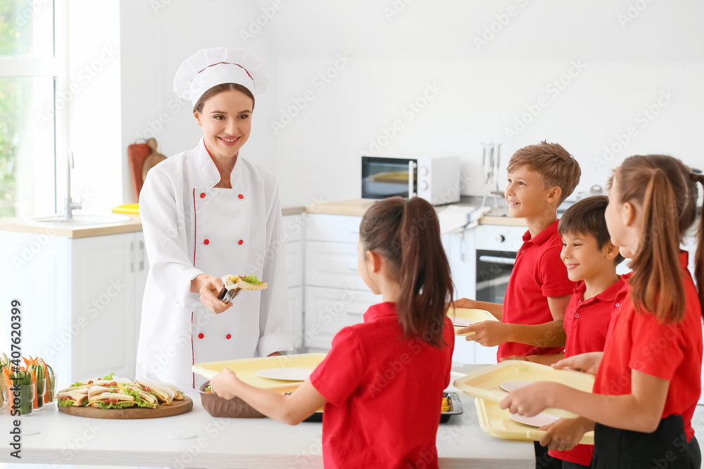 Pupils receiving lunch in school canteen Stock Photo | Adobe Stock