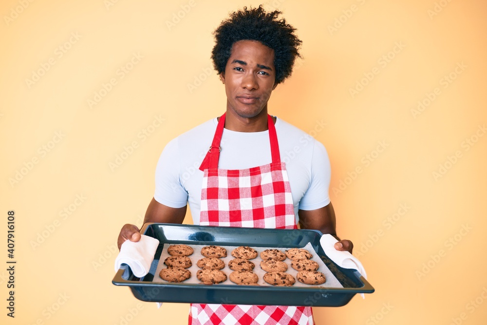 Handsome african american man with afro hair wearing baker uniform ...