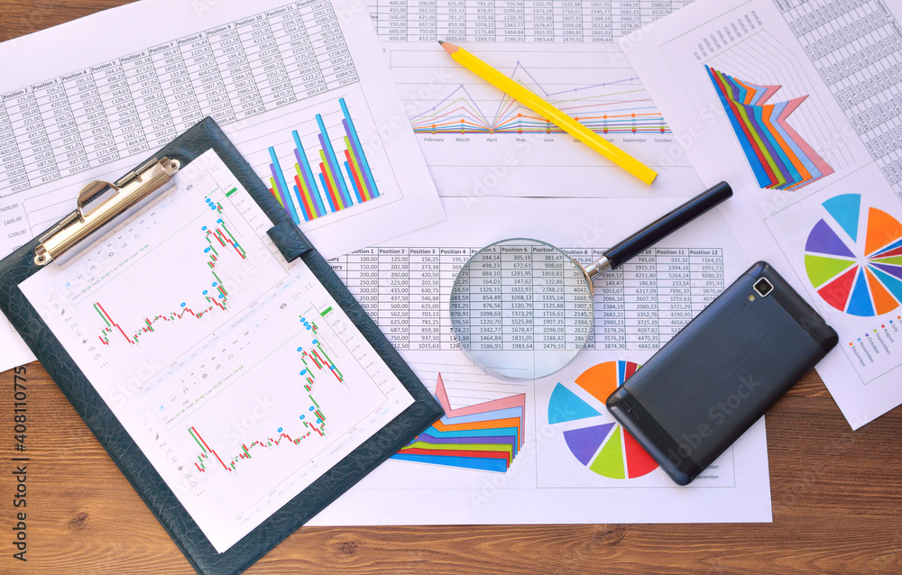 Financial documents - graphics, statistics, drawings, keyboard, laptop ...