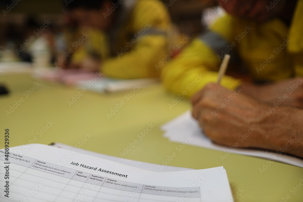 Clear image of job risk assessment booklet placing on the table with ...