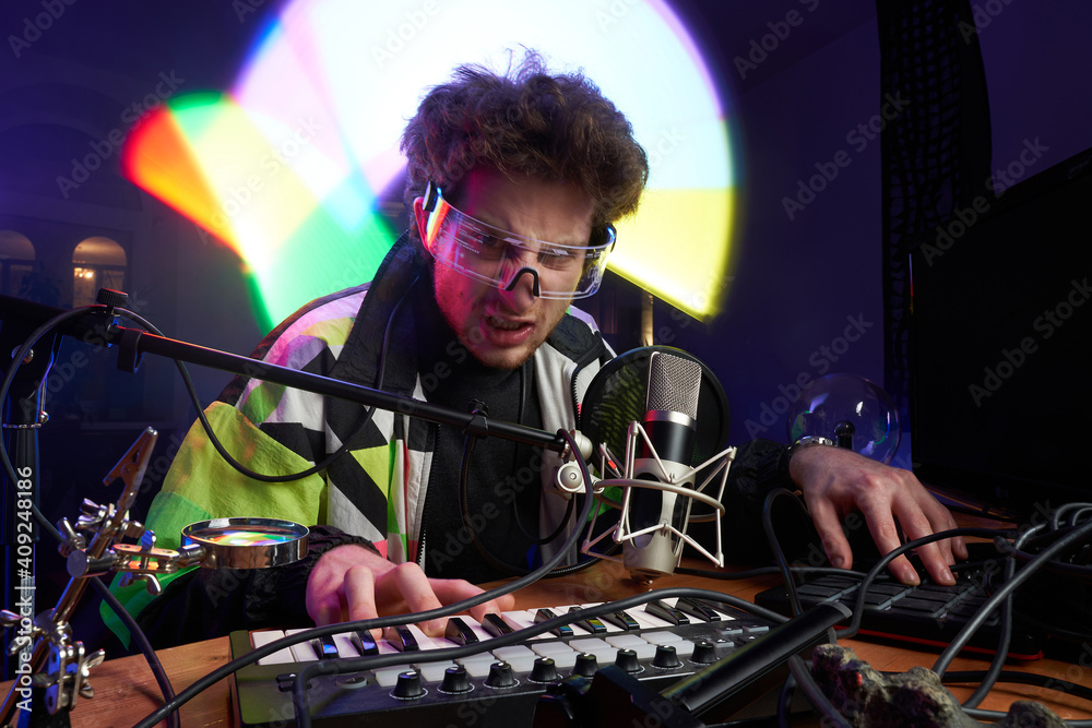 Foto de Stock Angry caucasian composer looks at camera and plays music ...