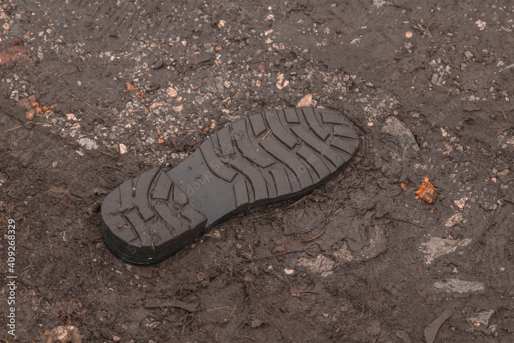 Underside of a shoe tread visible that it fell off and is now stuck in ...