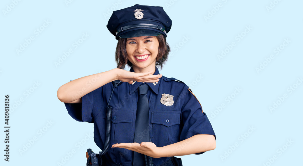 Young beautiful girl wearing police uniform gesturing with hands ...