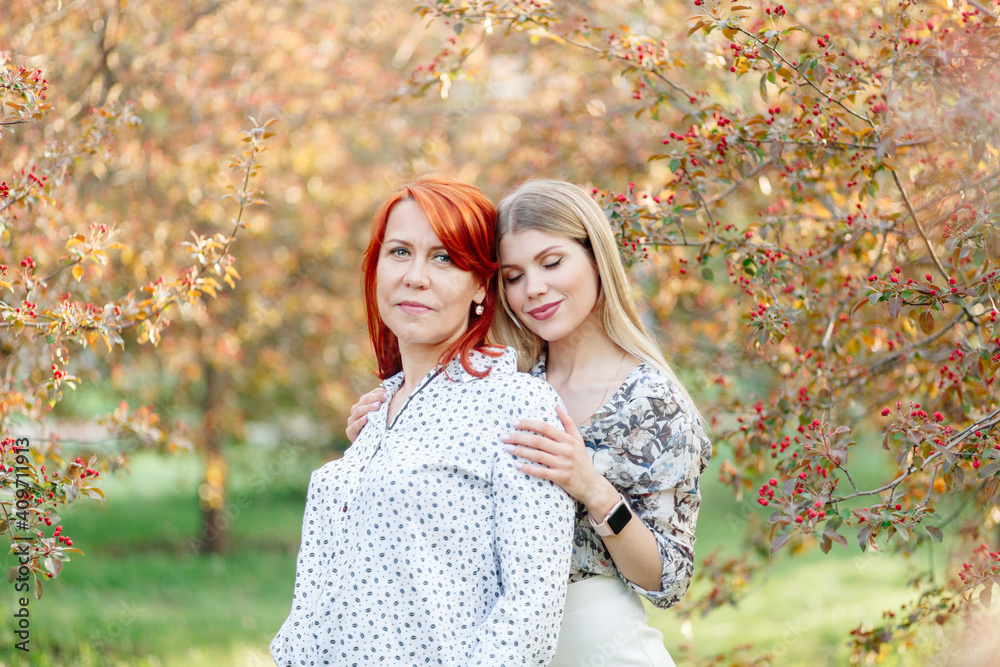 Stock-Foto „Portrait of two women in the rose garden. One woman is over ...