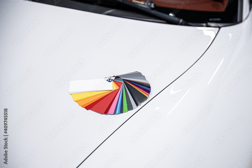 Man choosing color of his car with color sampler. Car foil wrapping ...