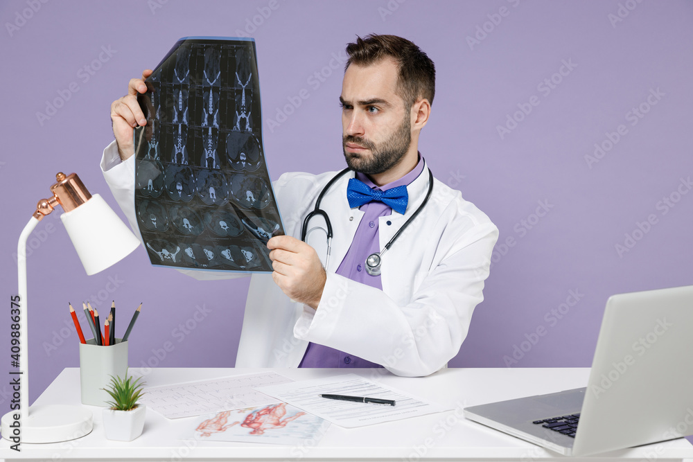 Intellectual doctor man holds x-ray radiographic image ct scan mri ...