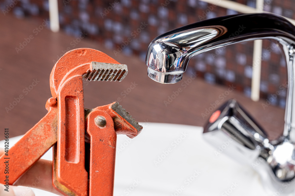 plumbing faucet repair concept. plumber using wrench tool and pliers to ...