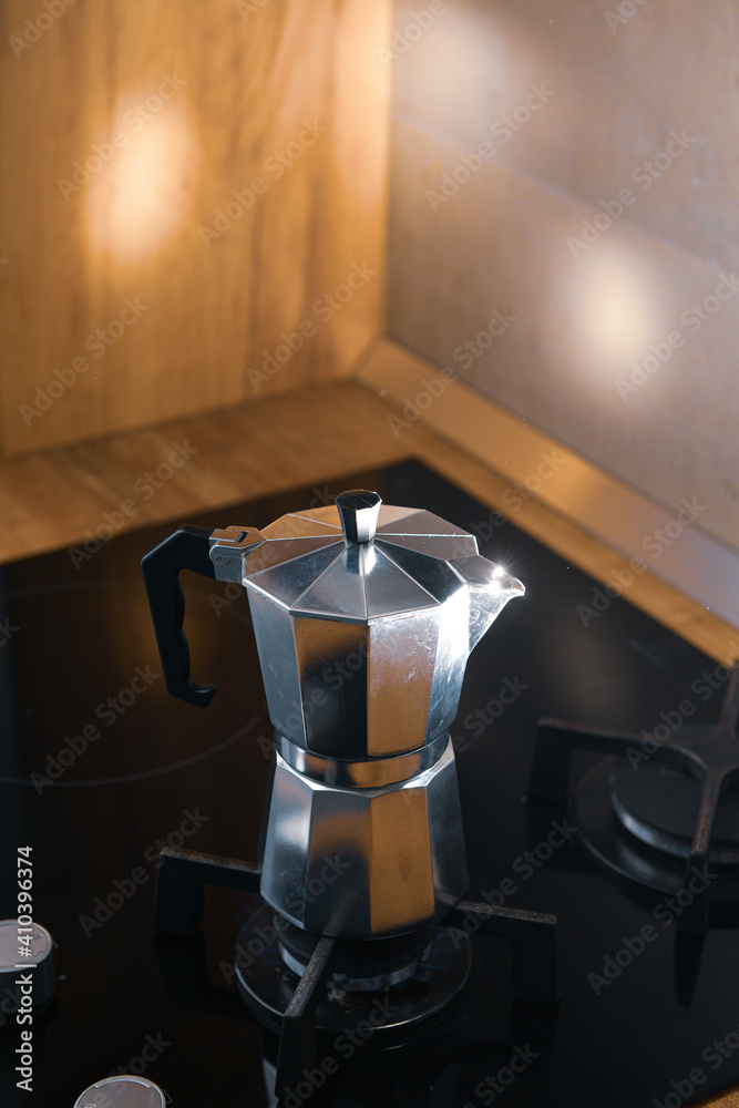 An Italian espresso mokka machine with steam getting out of it while ...
