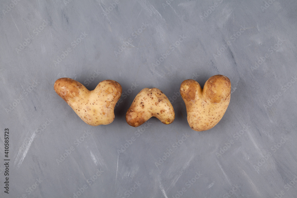 Ugly deformed potatoes on grey background, top view. Concept - Food ...