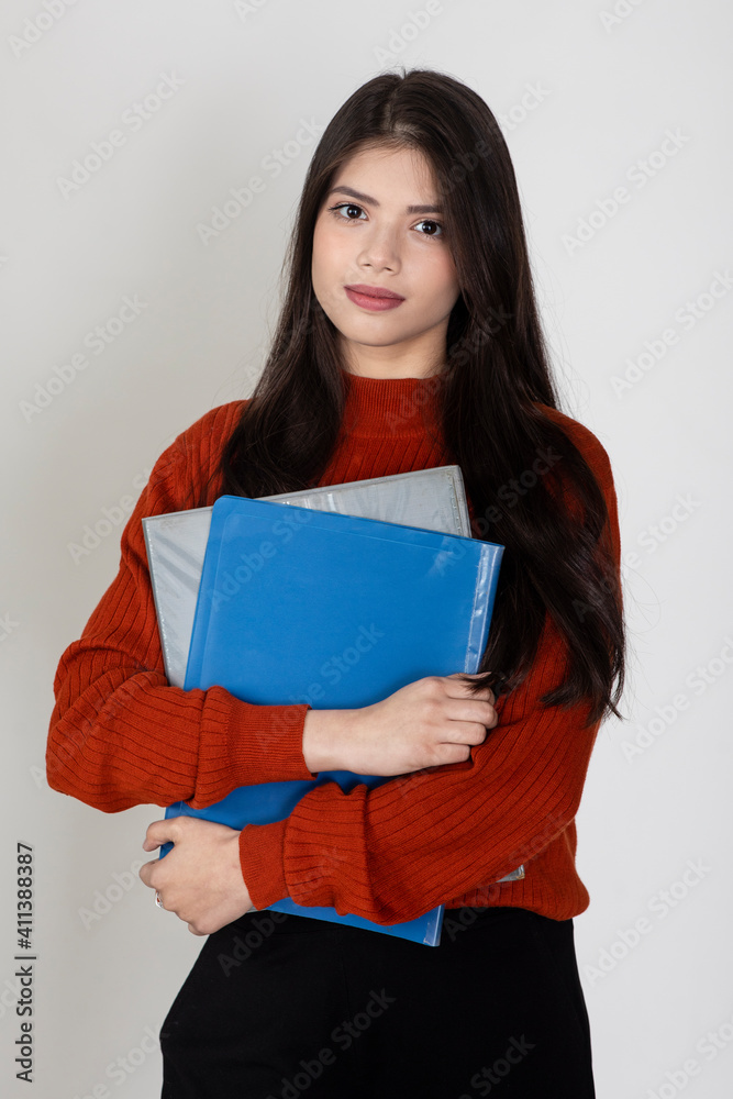 Portrait of a beautiful young lady wearing spectacles and holding ...