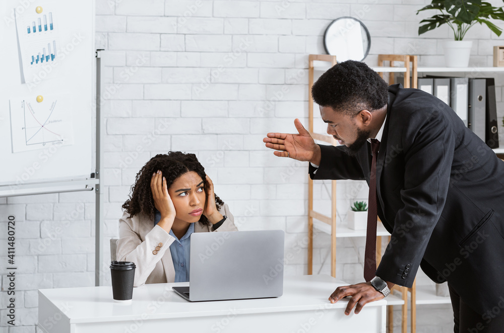 Displeased male boss scolding upset female employee for mistake in ...