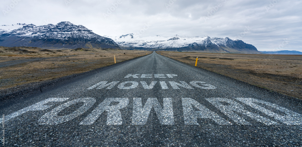Keep moving forward text quote written on asphalt road leading towards ...