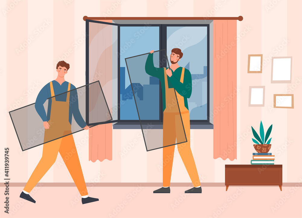 Two male workers in overalls installing mosquito net on plastic window ...