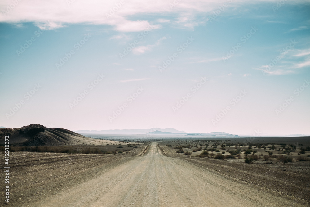 Long empty desert road heading into the horizon Stock Photo | Adobe Stock