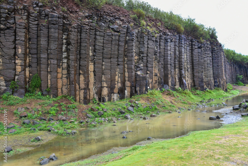Terracotta columnar basalt columns on the tropical island of Penghu ...
