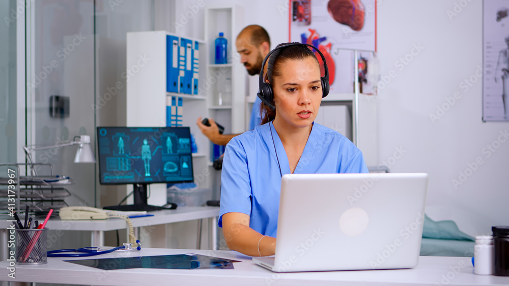 Medical assistant operator with headphone consulting patients during ...