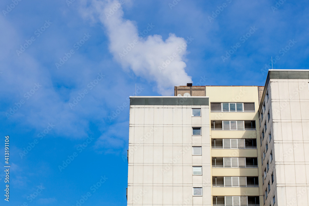 Facade of city apartments. Residential building with smoking chimney ...