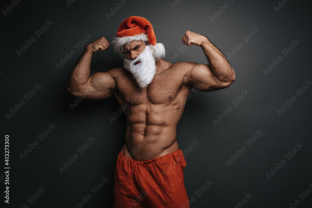 Shirtless muscular man in Santa hat with showing his muscles. Sexy ...