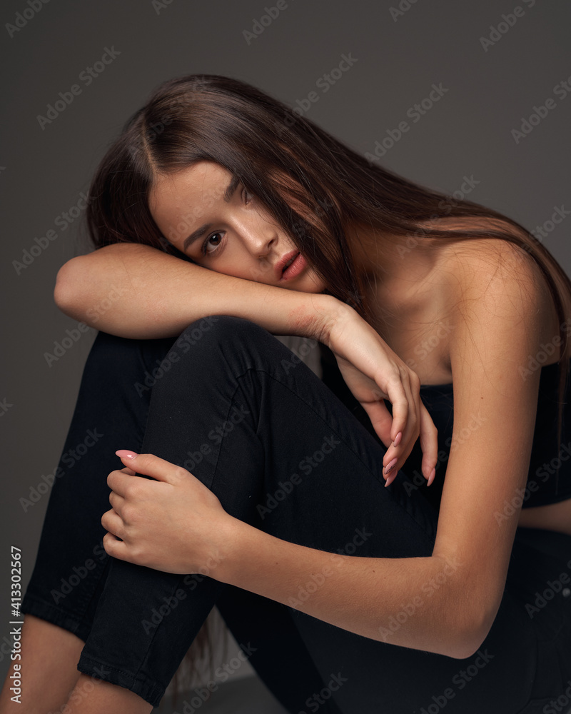 Full length studio portrait of young slim tanned caucasian girl in ...