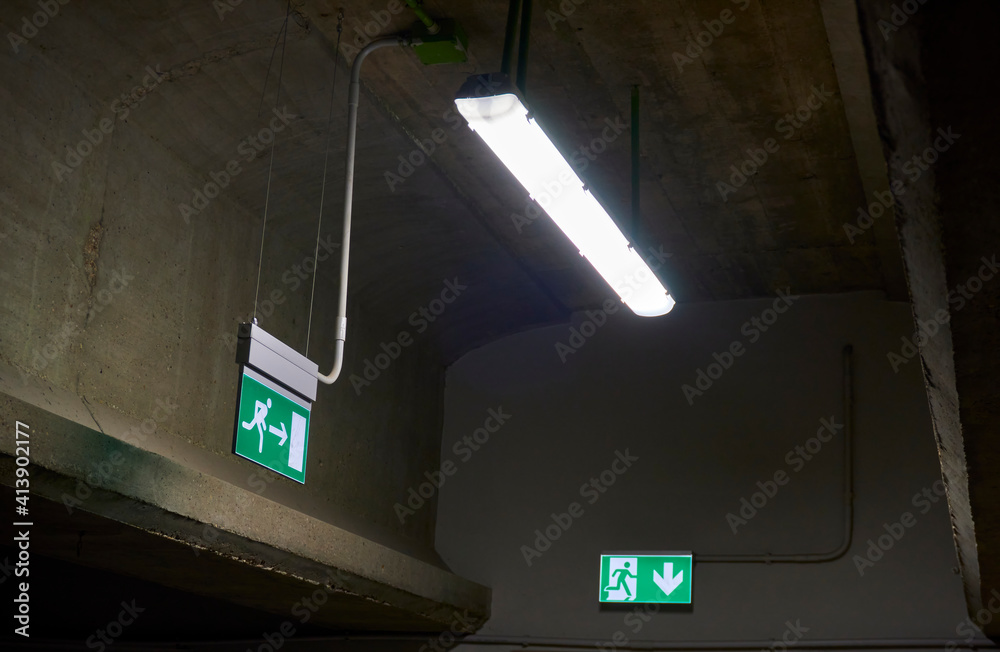 Underground garage emergency exit and indicators Stock Photo | Adobe Stock