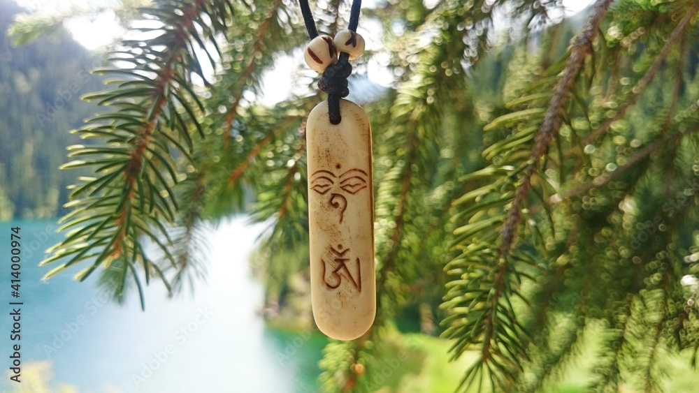 Macro symbol OM (AUM). A locket with OM symbol. The background is ...