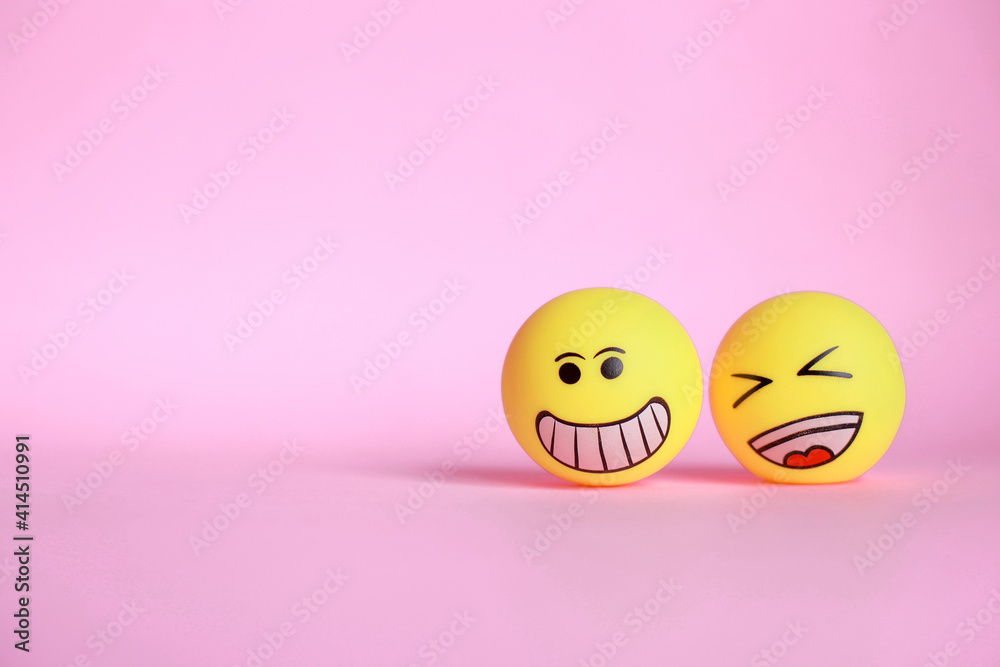 Smiley emoticon with laugh emoticon isolated on pink background with ...