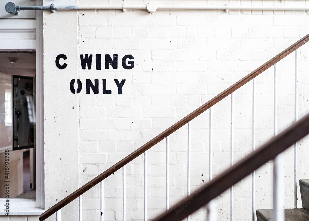 Staircase to C Wing for prisoners in old run down jail house high ...